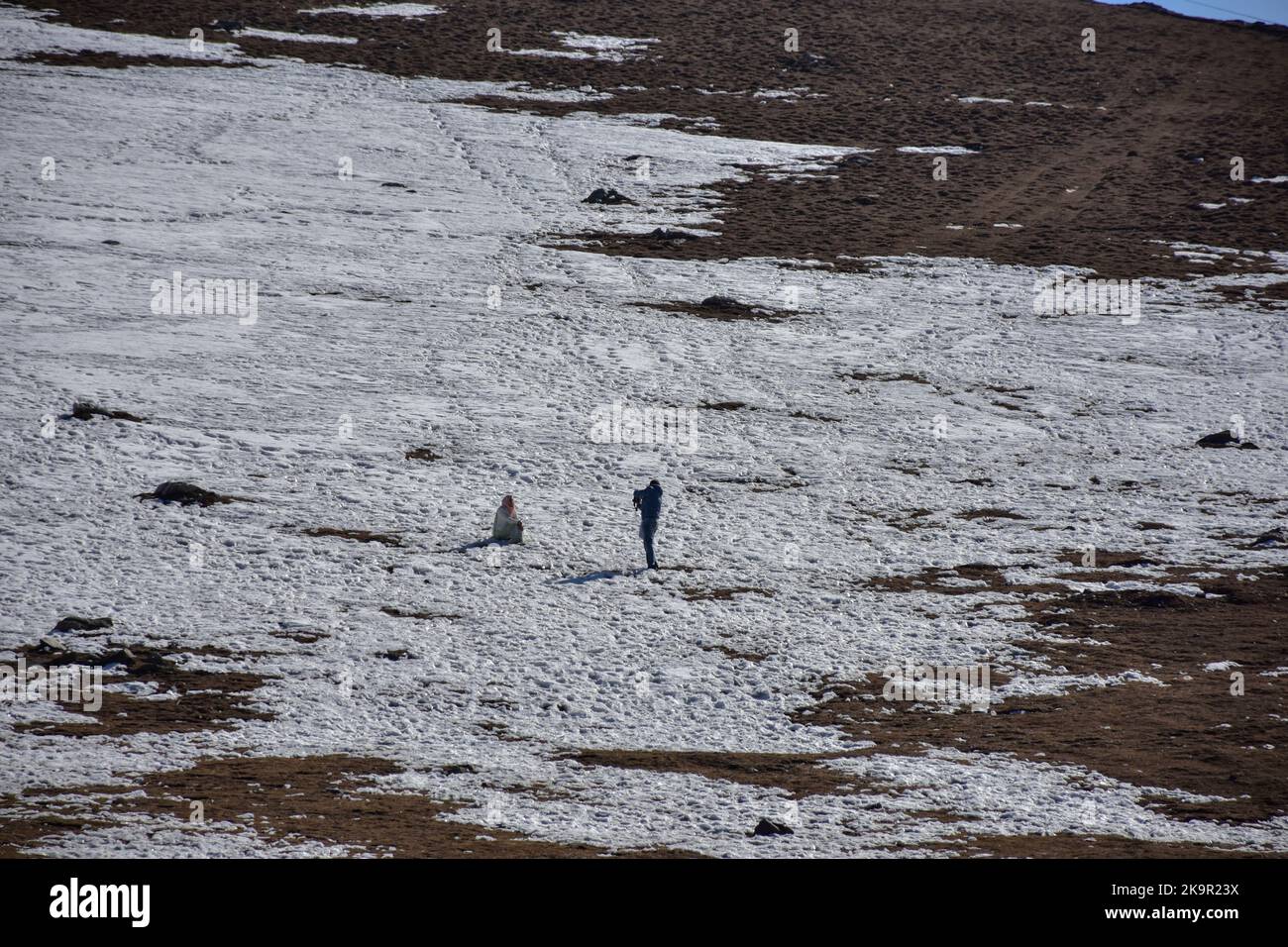 Visitors take pictures at the snow covered Pir Panjal Pass, also called ...