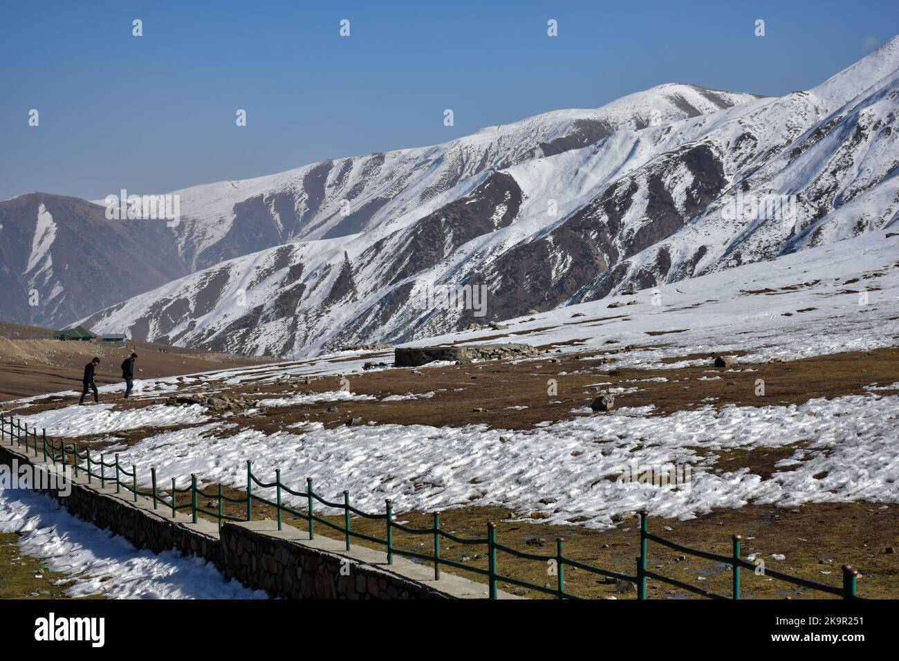 Visitors walk along the snow covered Pir Panjal Pass, also called Peer ...