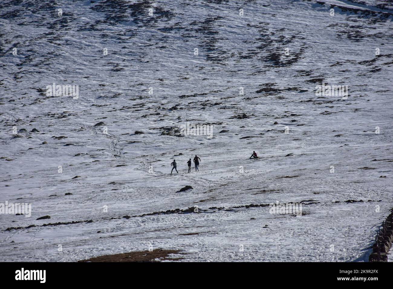 Visitors walk along the snow covered Pir Panjal Pass, also called Peer ...