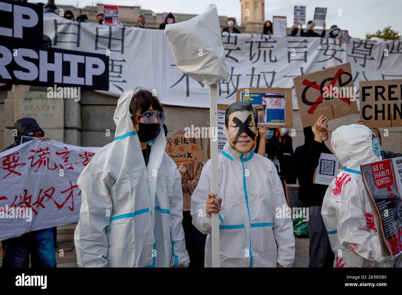 Protesters seen wearing PPE and a mask of Xi Jinping to protest against ...
