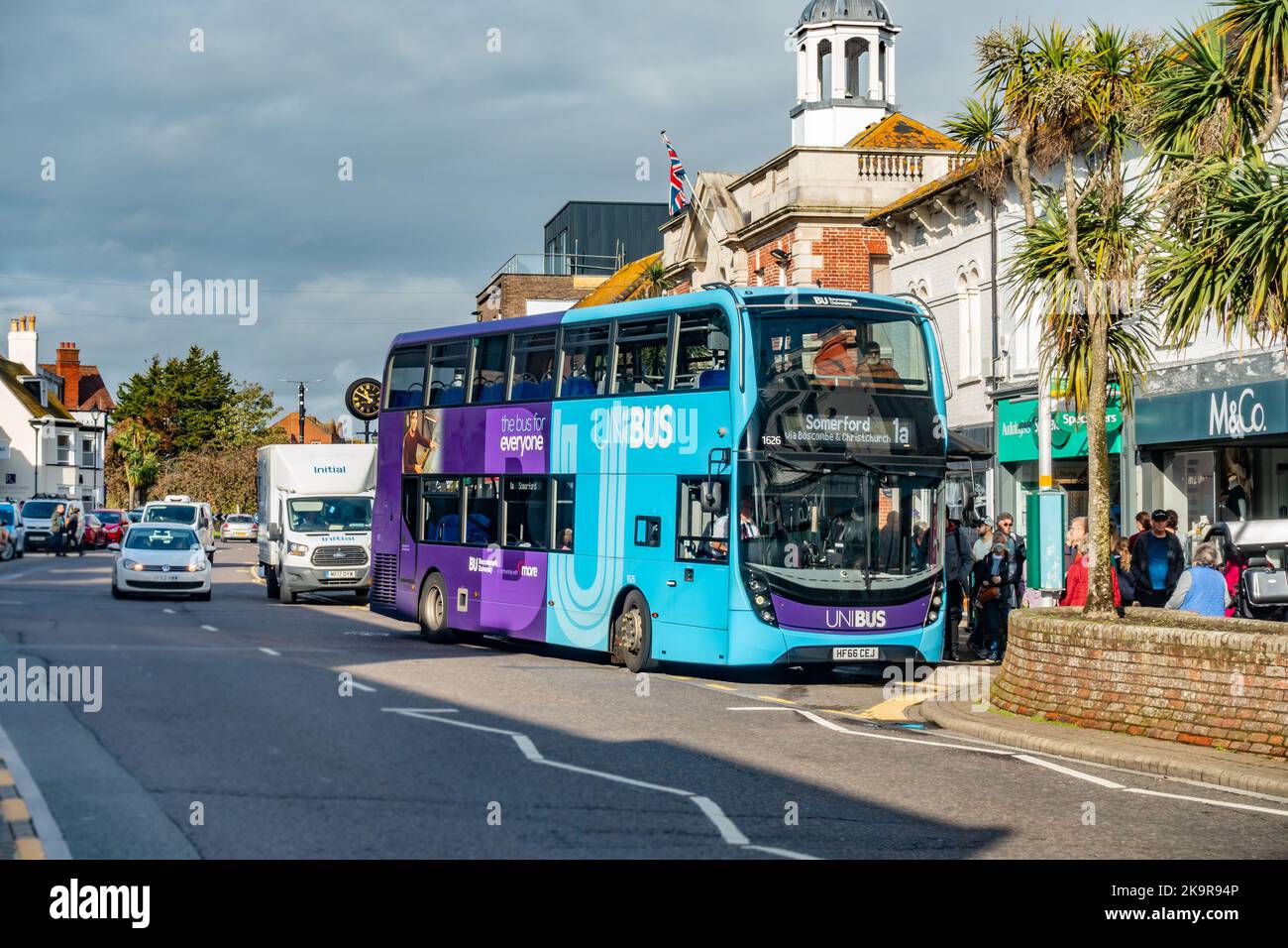 A blue and purple double decker bus operated by Unibus pulled into a ...