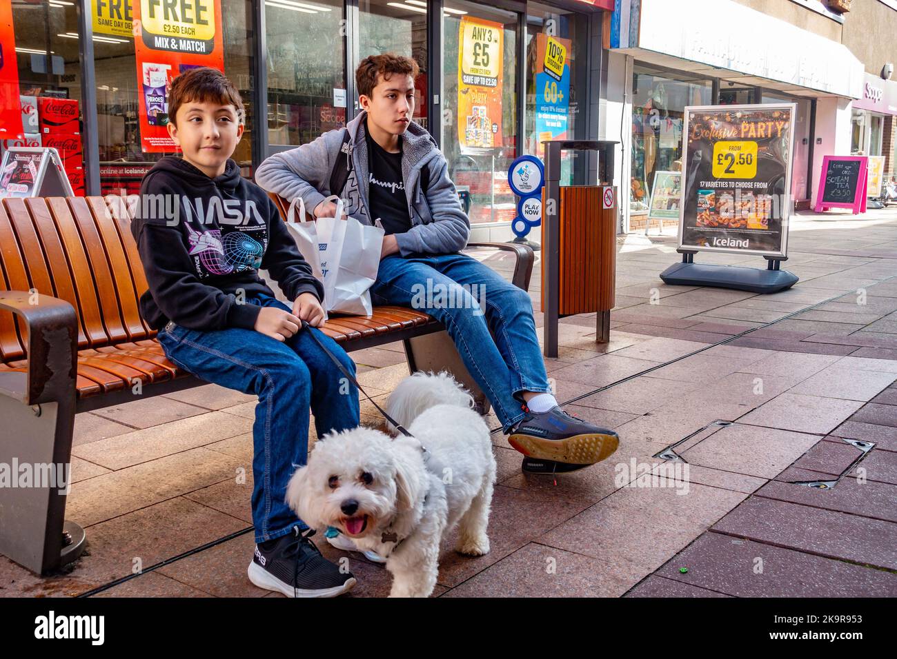 Young brothers sit on a bench in Saxon Square shopping centre in ...