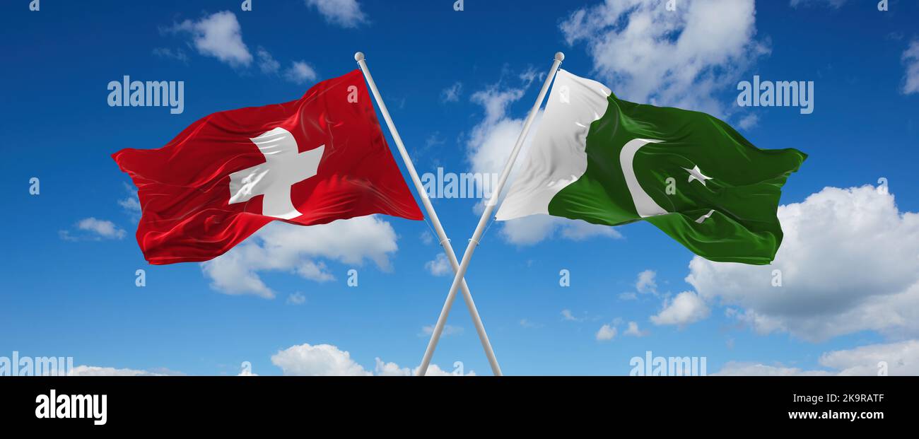 two crossed flags Pakistan and Switzerland waving in wind at cloudy sky ...