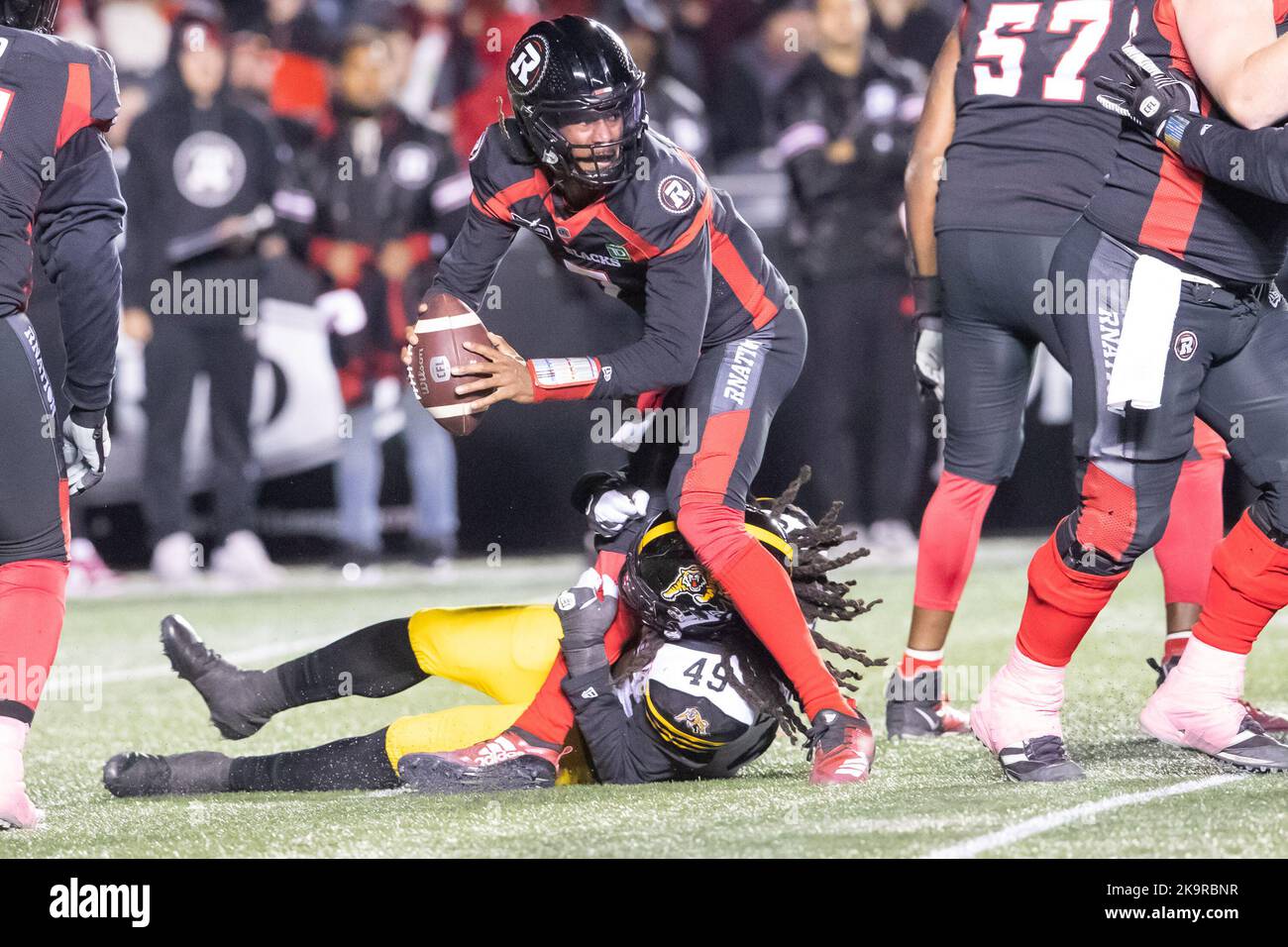 October 29, 2022: Ottawa Redblacks quarterback Tyrie Adams (7) escapes ...