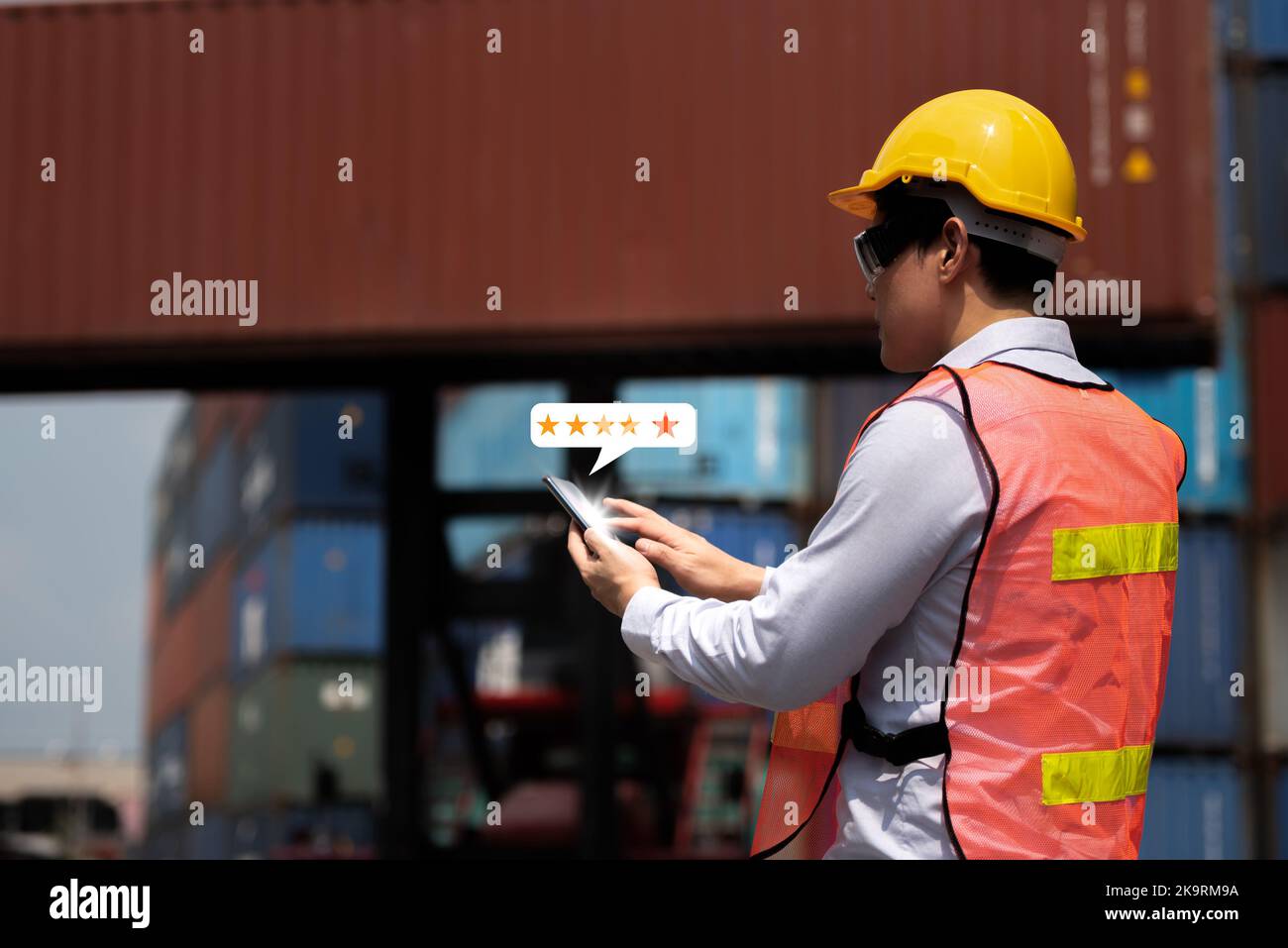 Industrial male worker using mobile phone to rating five stars for ...