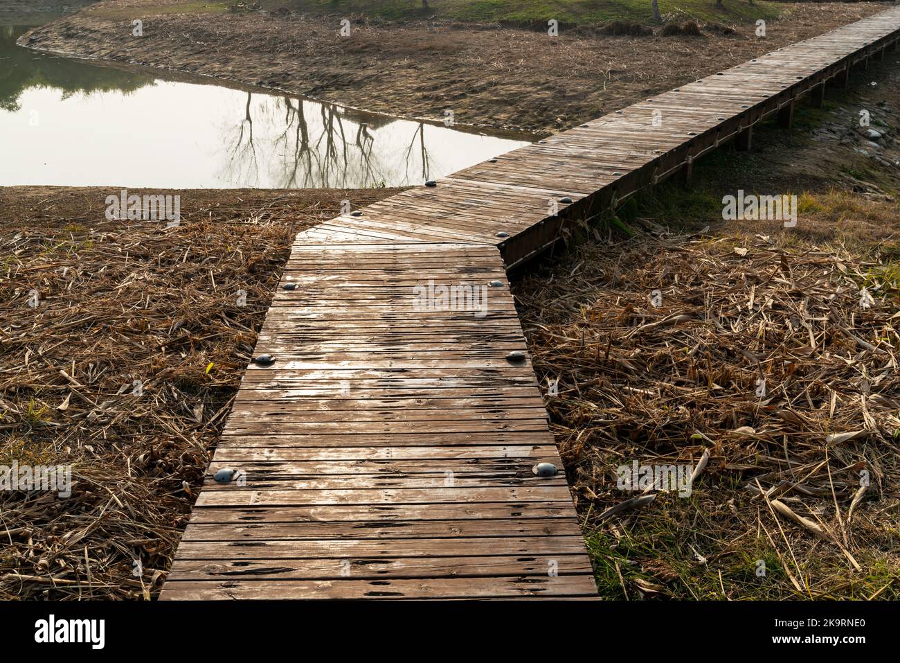 Wooden bridge over little river in city park Stock Photo - Alamy