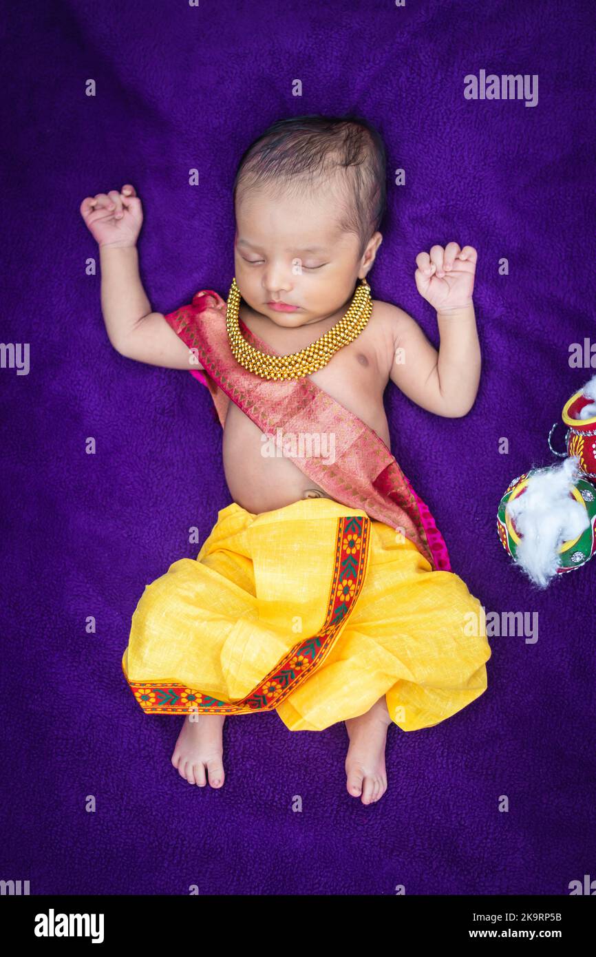 newborn baby boy in krishna dressed with props from unique perspective ...