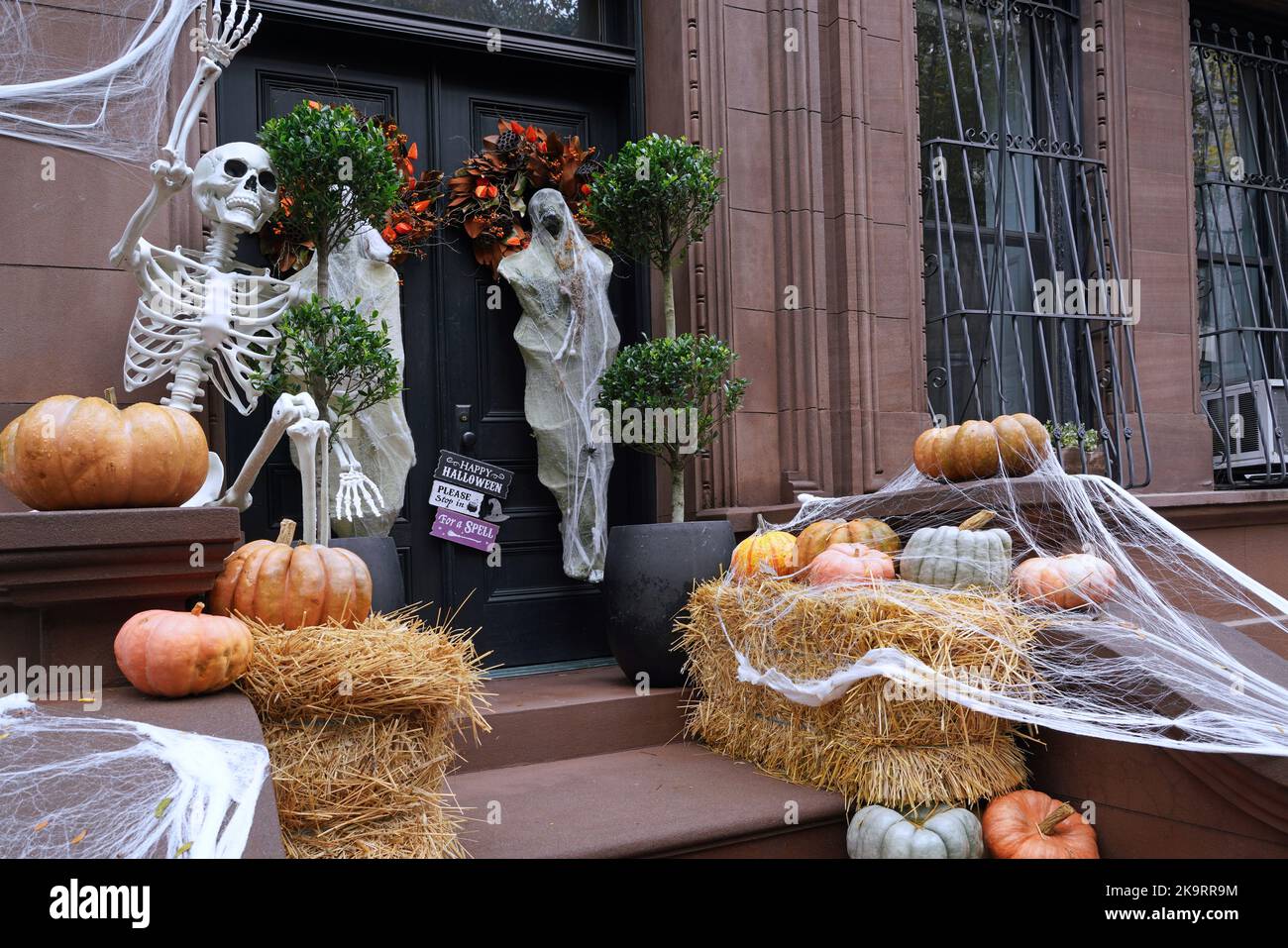 Front door with Halloween decorations including life size skeleton ...