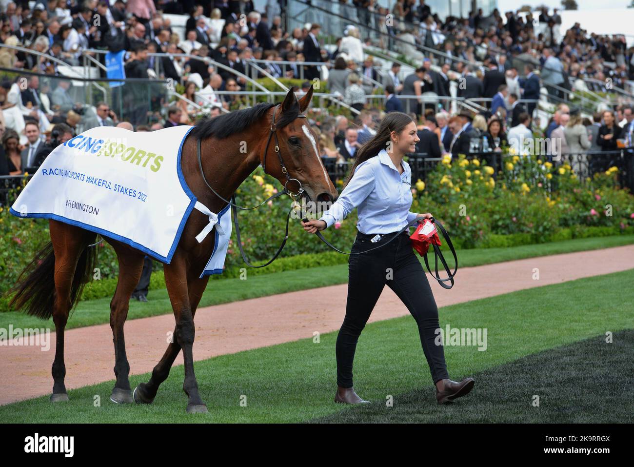 Jockeys and people take part during Melbourne Cup Carnival 2022 at ...