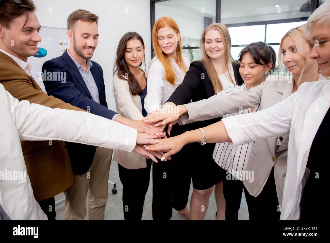 Group of business team harmonious with man and woman joining hands stack together in enterprise ...
