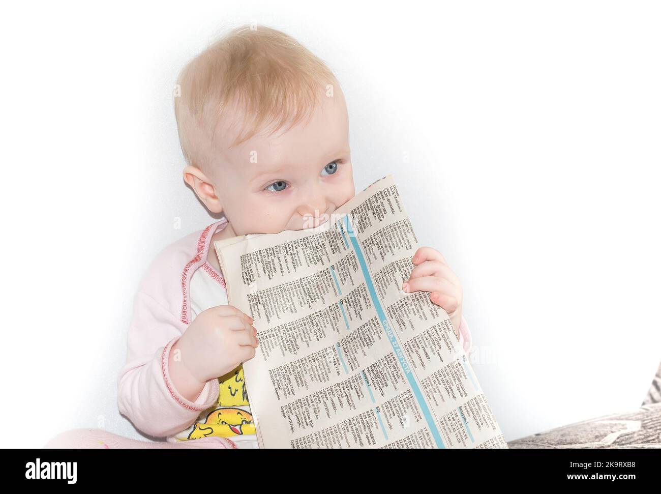 little child holding a newspaper on a white background Stock Photo - Alamy