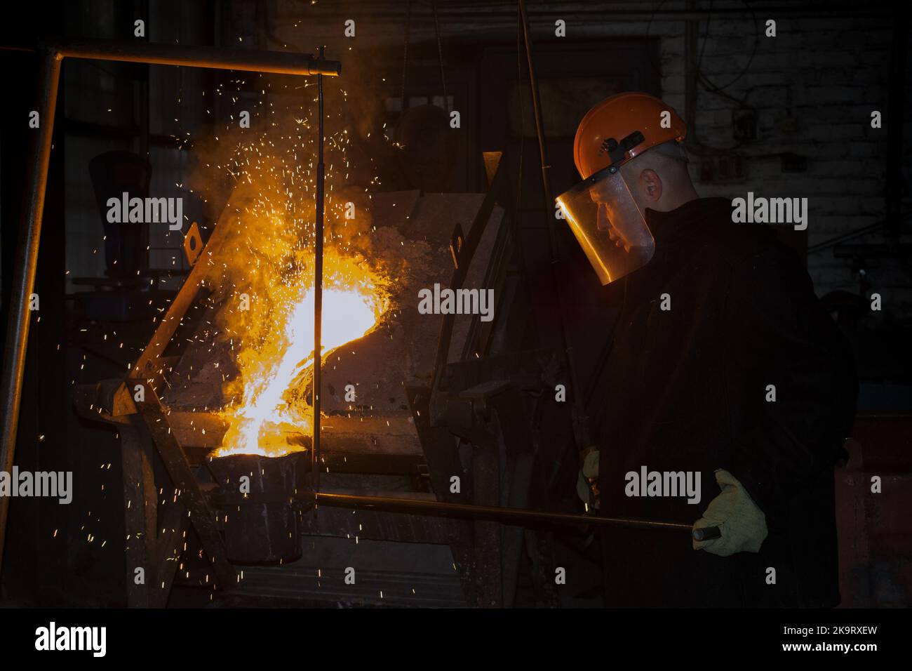smelter worker pours liquid metal into a casting mold Stock Photo - Alamy