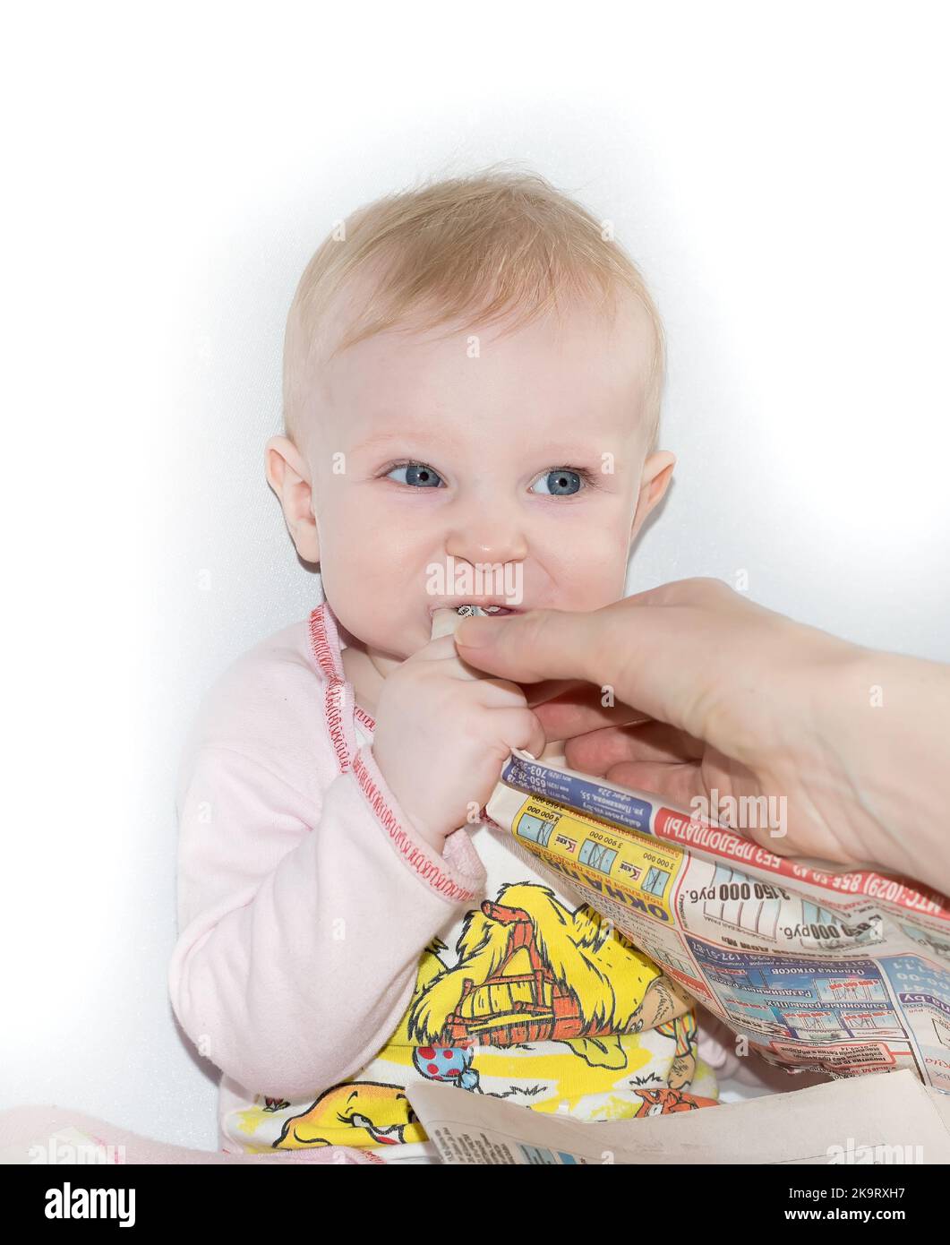 little child holding a newspaper on a white background Stock Photo - Alamy