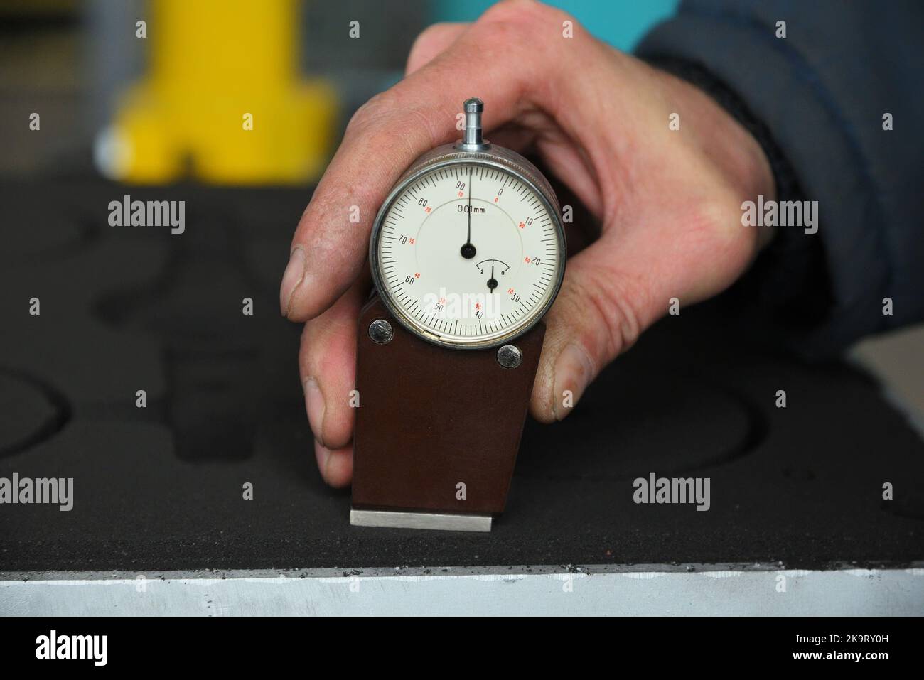 worker's hand holds a dial gauge for measuring the hardness Stock Photo ...