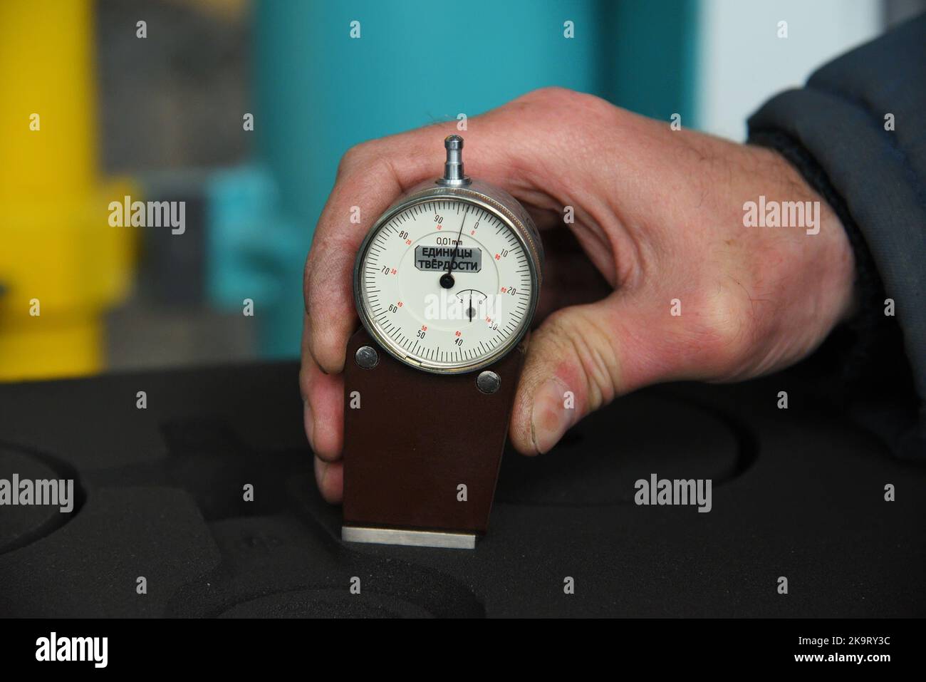 worker's hand holds a dial gauge for measuring the hardness Stock Photo ...