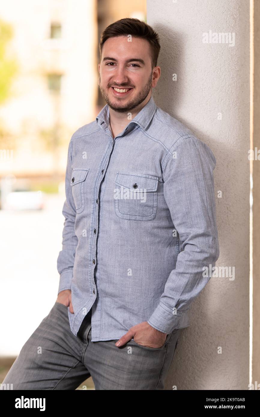 Happy Young Man In Blue Shirt Standing Outside And Smiling Stock Photo ...