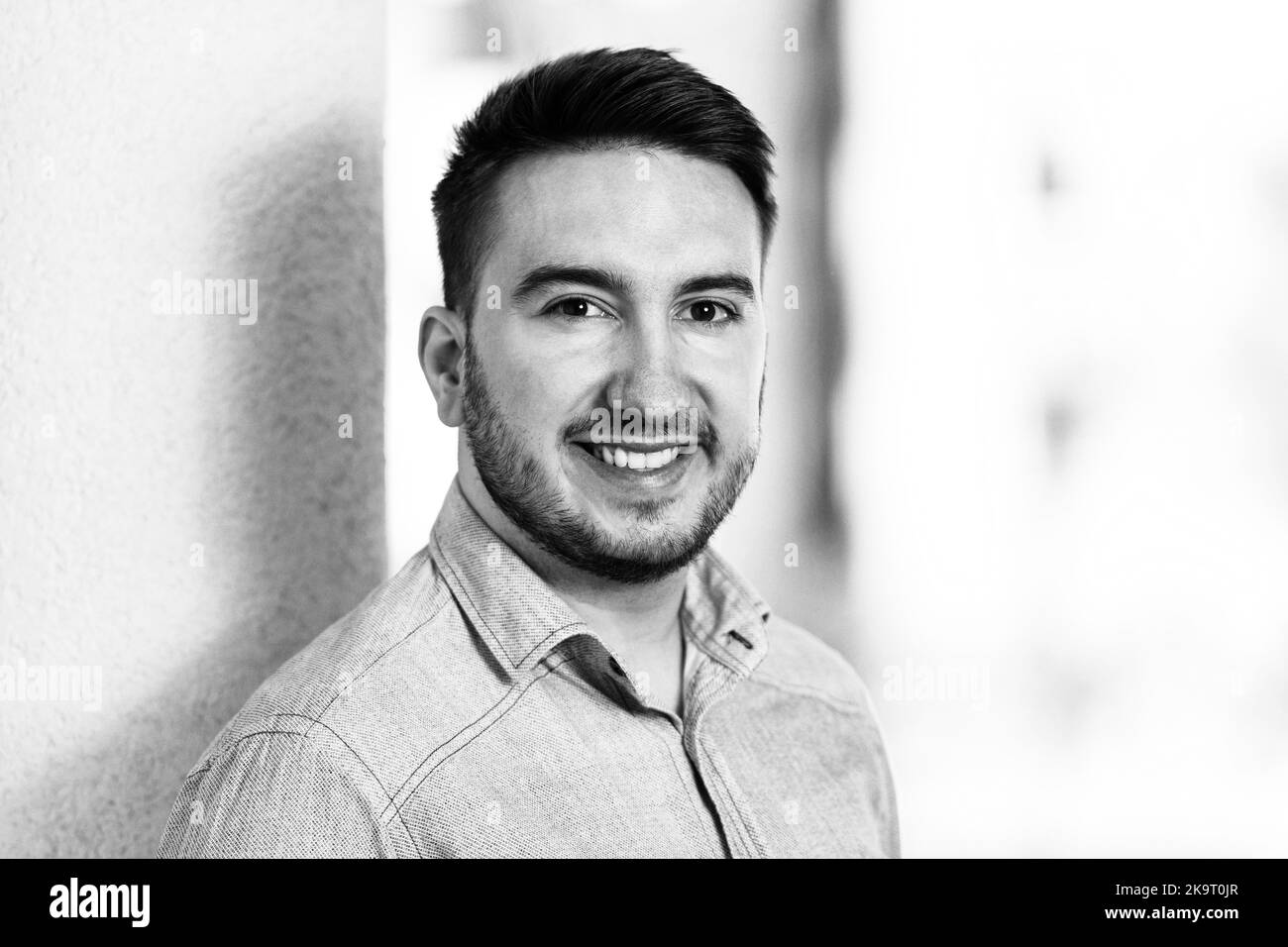 Smiling young man standing outside Black and White Stock Photos ...
