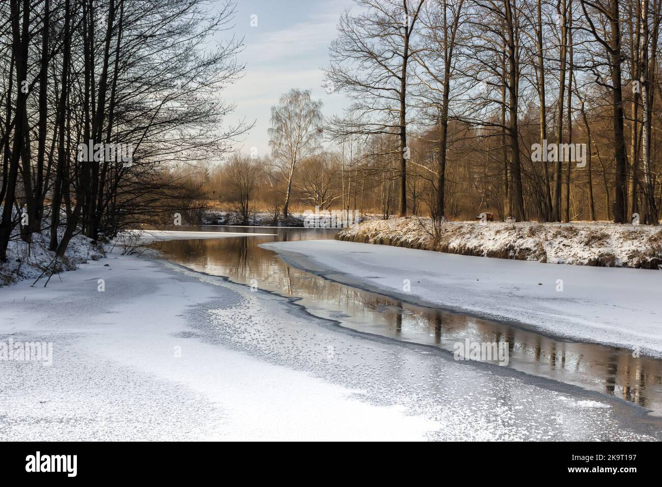frozen snowy river banks scenery Stock Photo - Alamy
