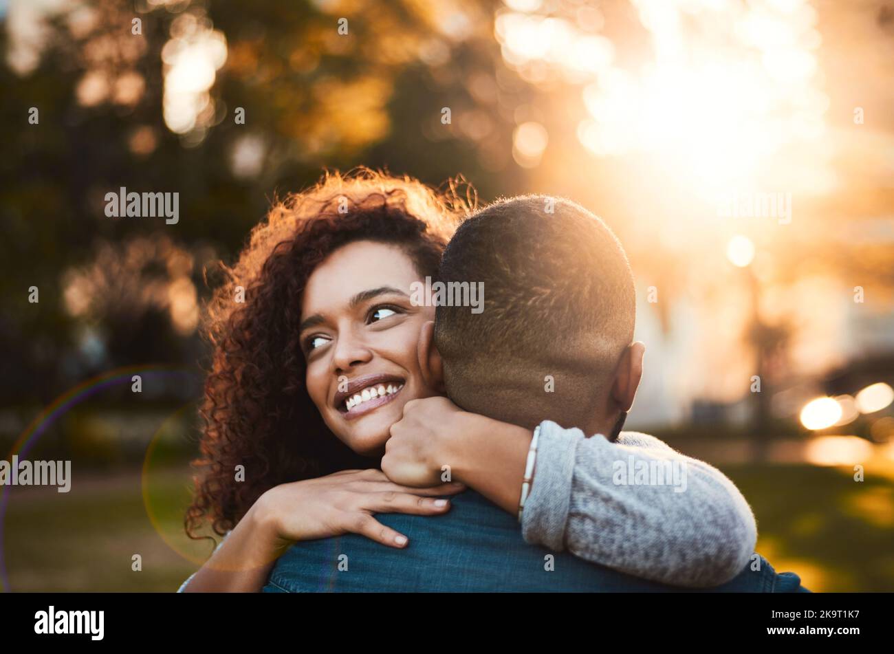 You complete me. a young woman hugging her boyfriend outdoors Stock Photo - Alamy