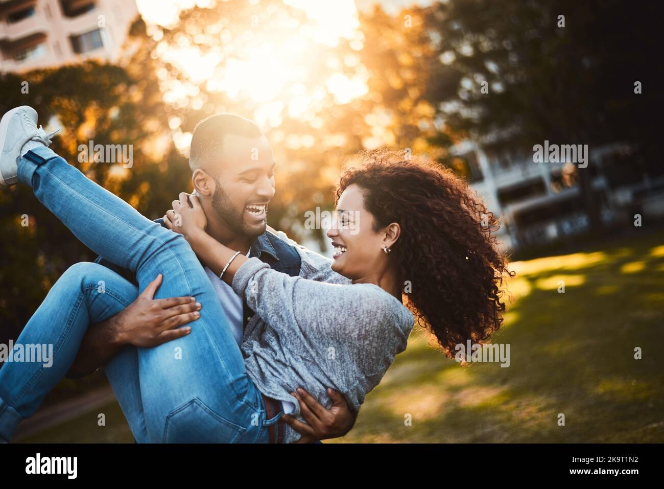 He knows how to sweep her off her feet. a young couple having fun ...