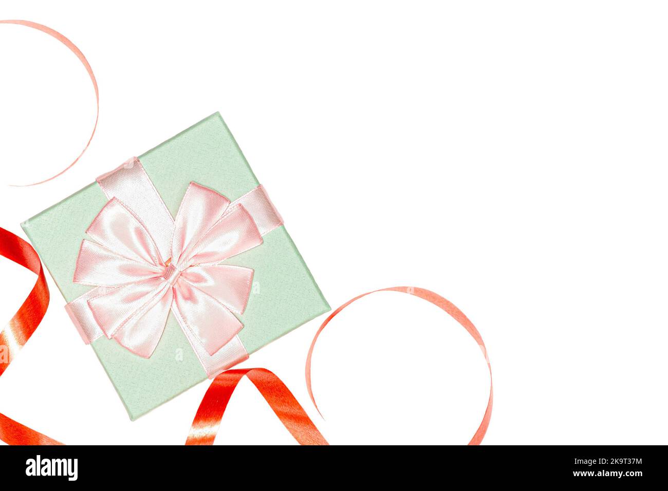 Christmas concept, Green pastel gift box wraps pink satin ribbon and ...