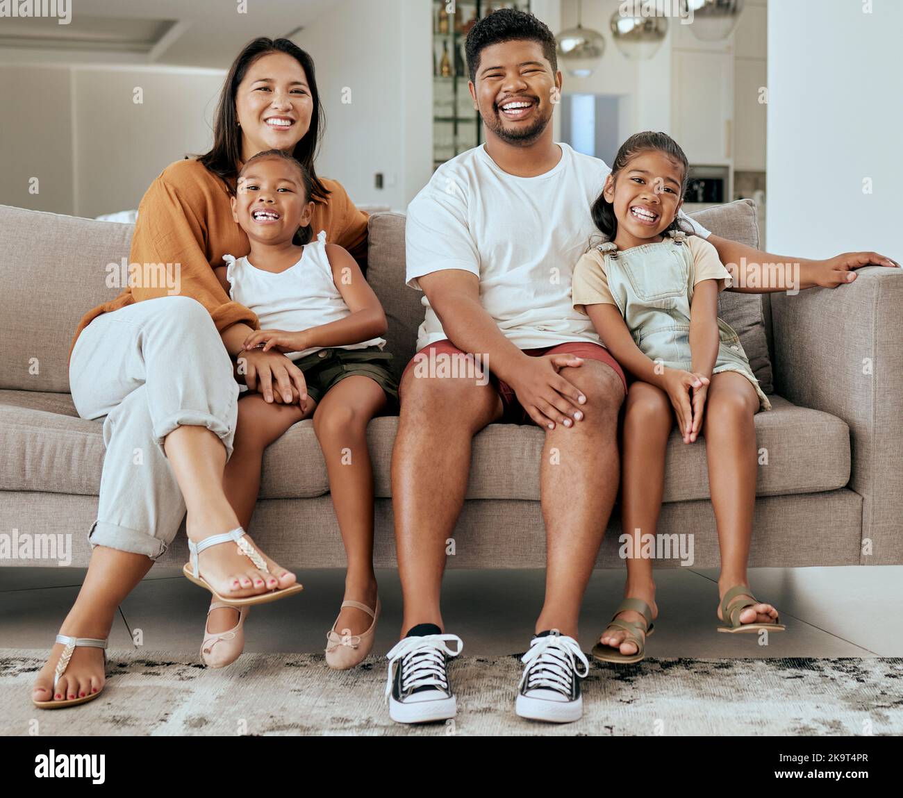 Portrait, happy family and relax on sofa together in holiday living ...