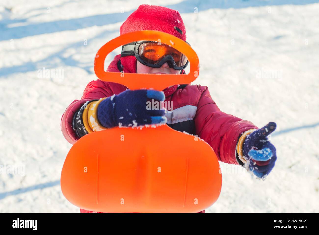 Boy sledging down a snowy hill hi-res stock photography and images - Alamy