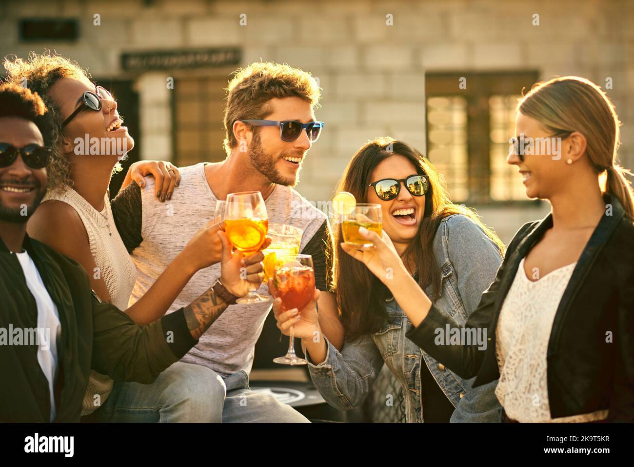 Make time for fun times. a group of young friends hanging out and ...