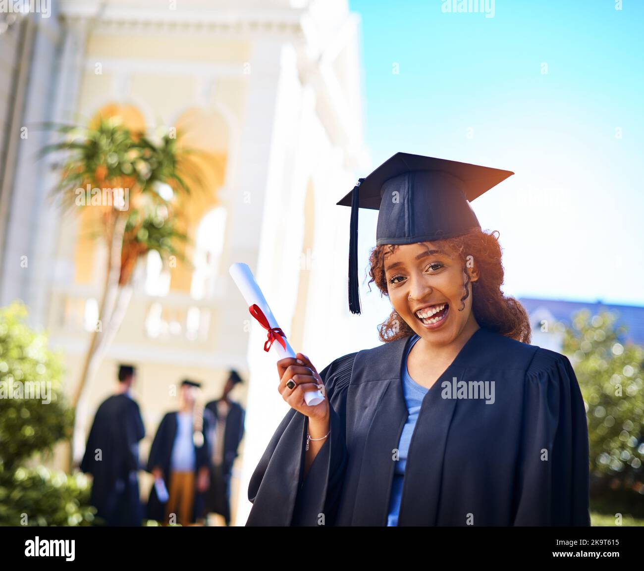Graduating is a huge accomplishment. a happy young woman holding her ...