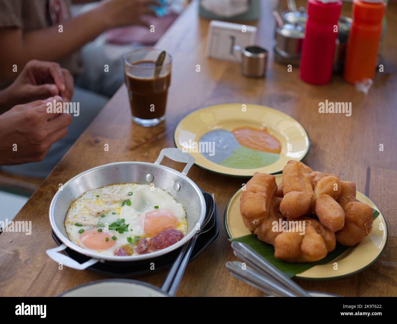 Panned Eggs Thai style or Pan Fried Eggs with ham, sausages, and ...