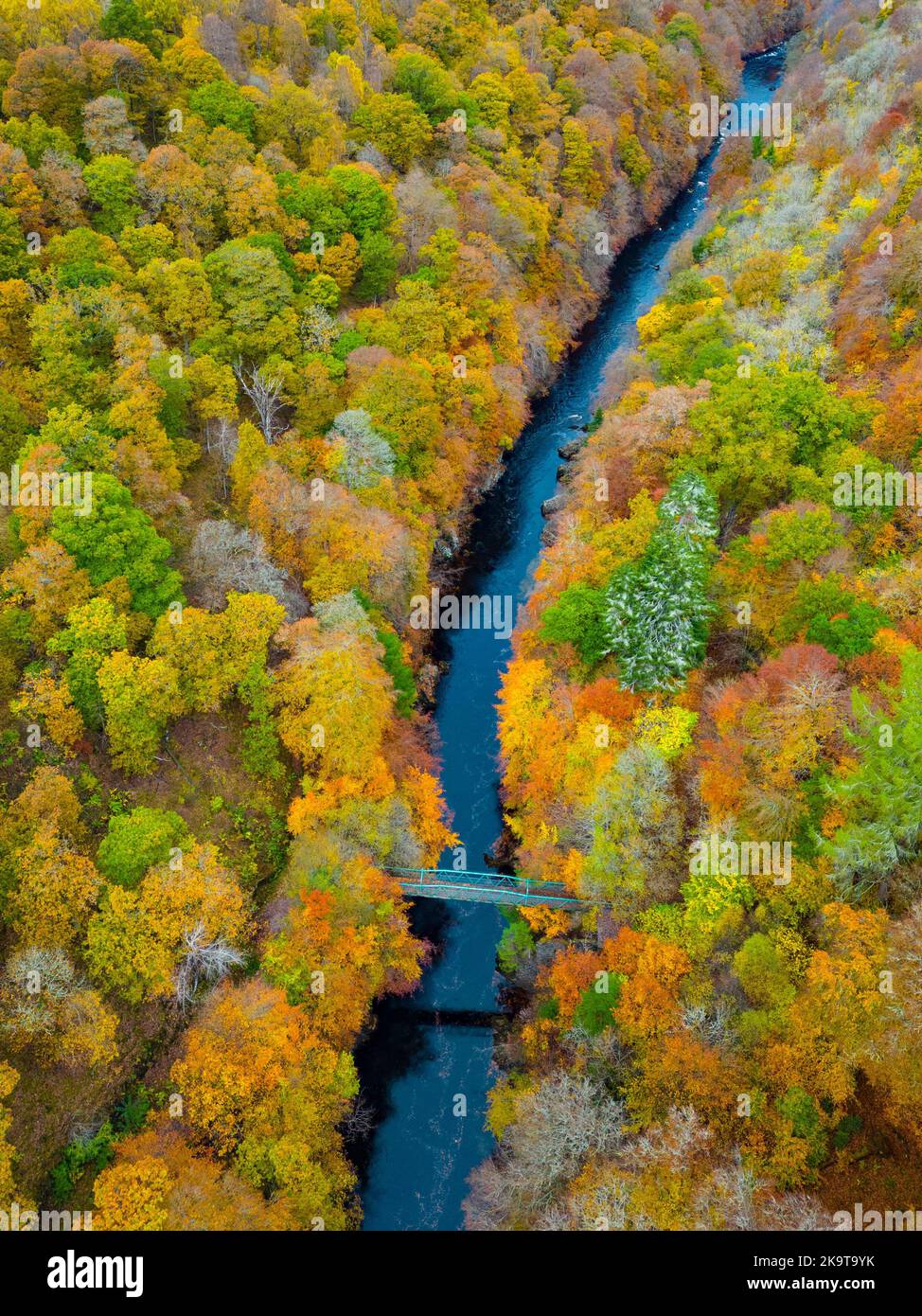 Aerial view of late autumn colours in trees beside the River Garry near ...