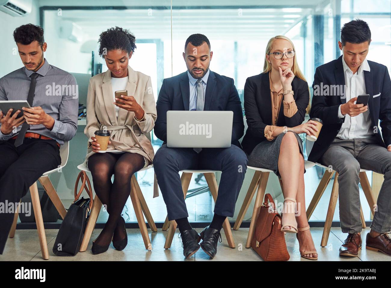 The waiting game at its best. a group of focussed young businesspeople ...