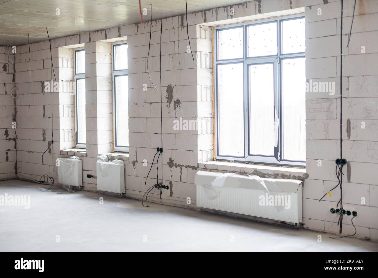 new white heat radiators hang on the wall under the window under ...