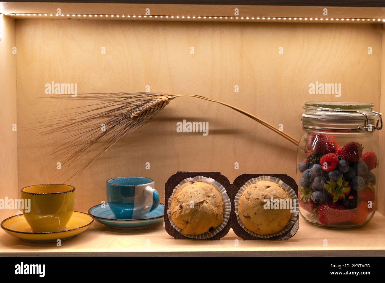 Two Muffins, Two Cups of Coffee, Glass Jar with Red Fruits and an Ear ...