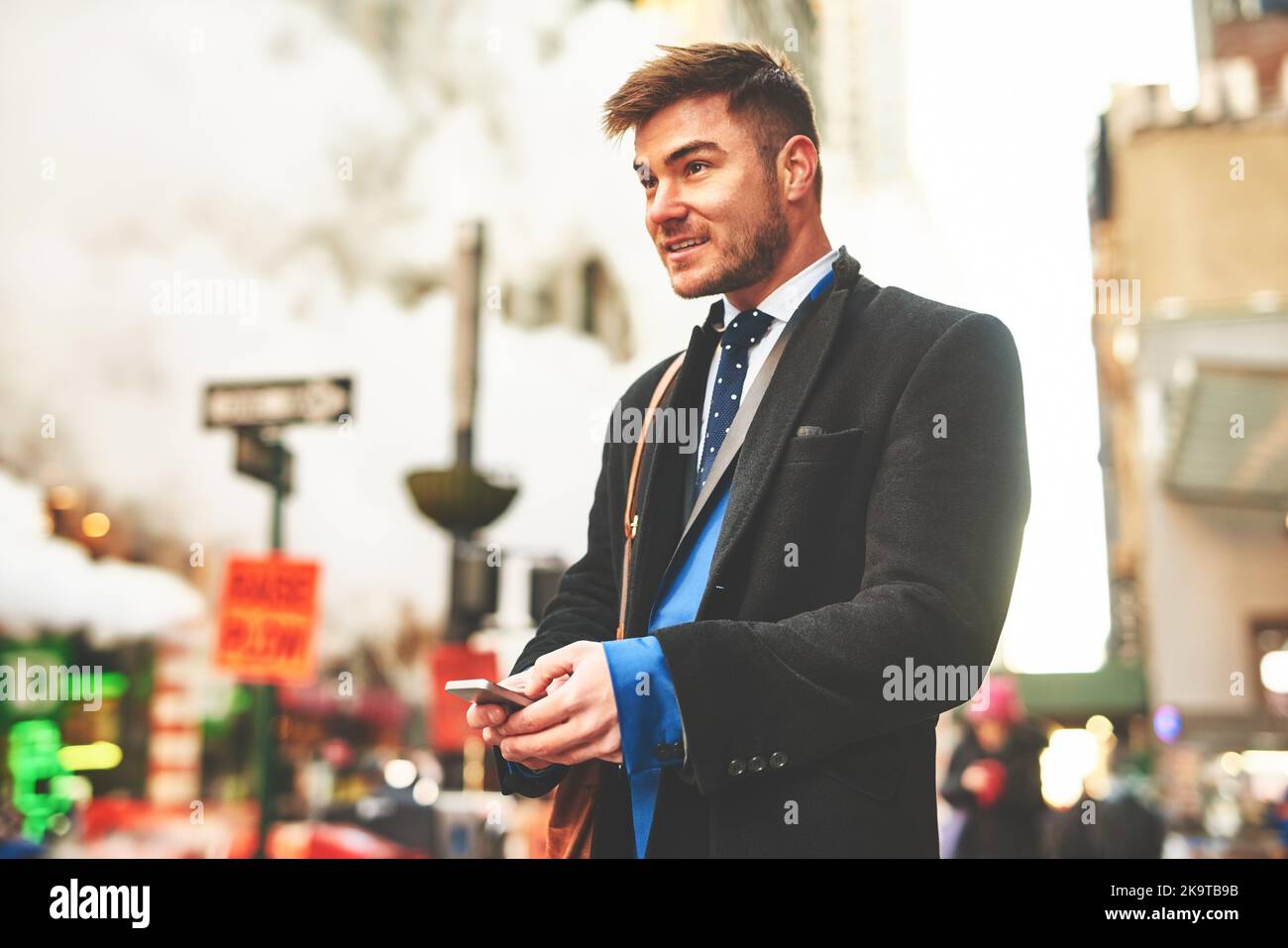 Am I at the right place. a young well dressed man texting on his ...