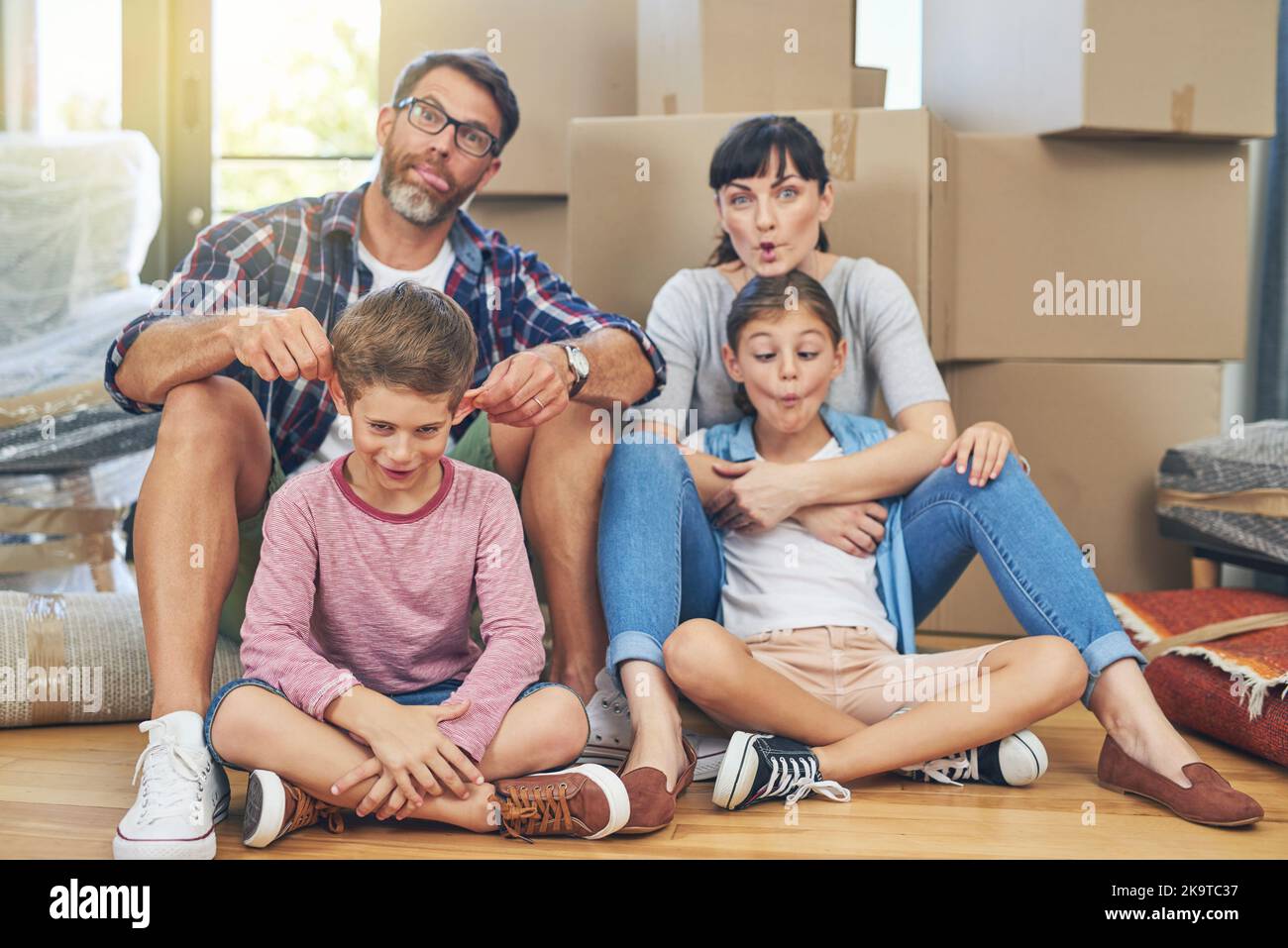 Were all crazy here. Portrait of a happy family making funny faces ...