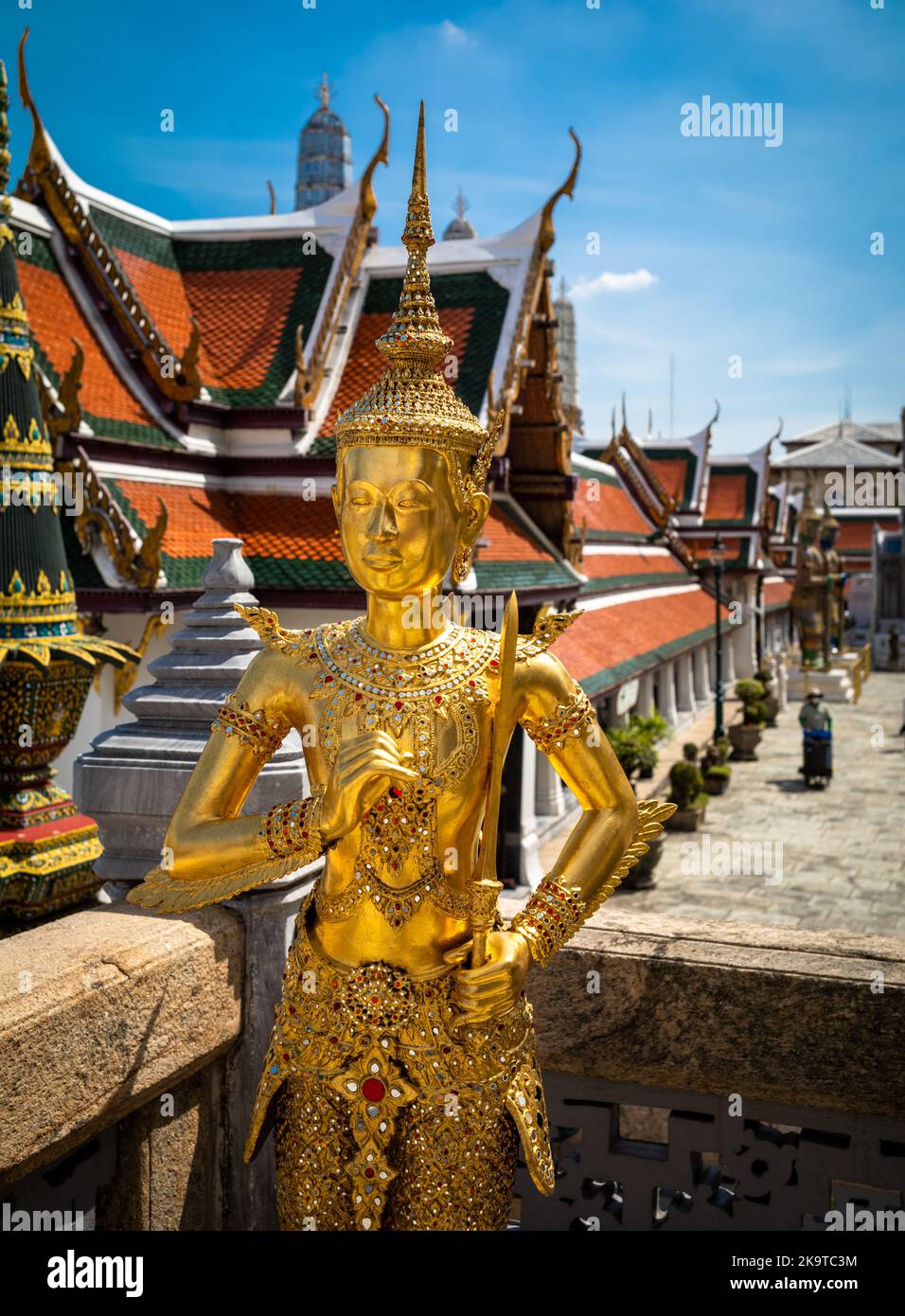 A golden Buddhist statue guardian statue by the Golden Stupa (Phra Si ...