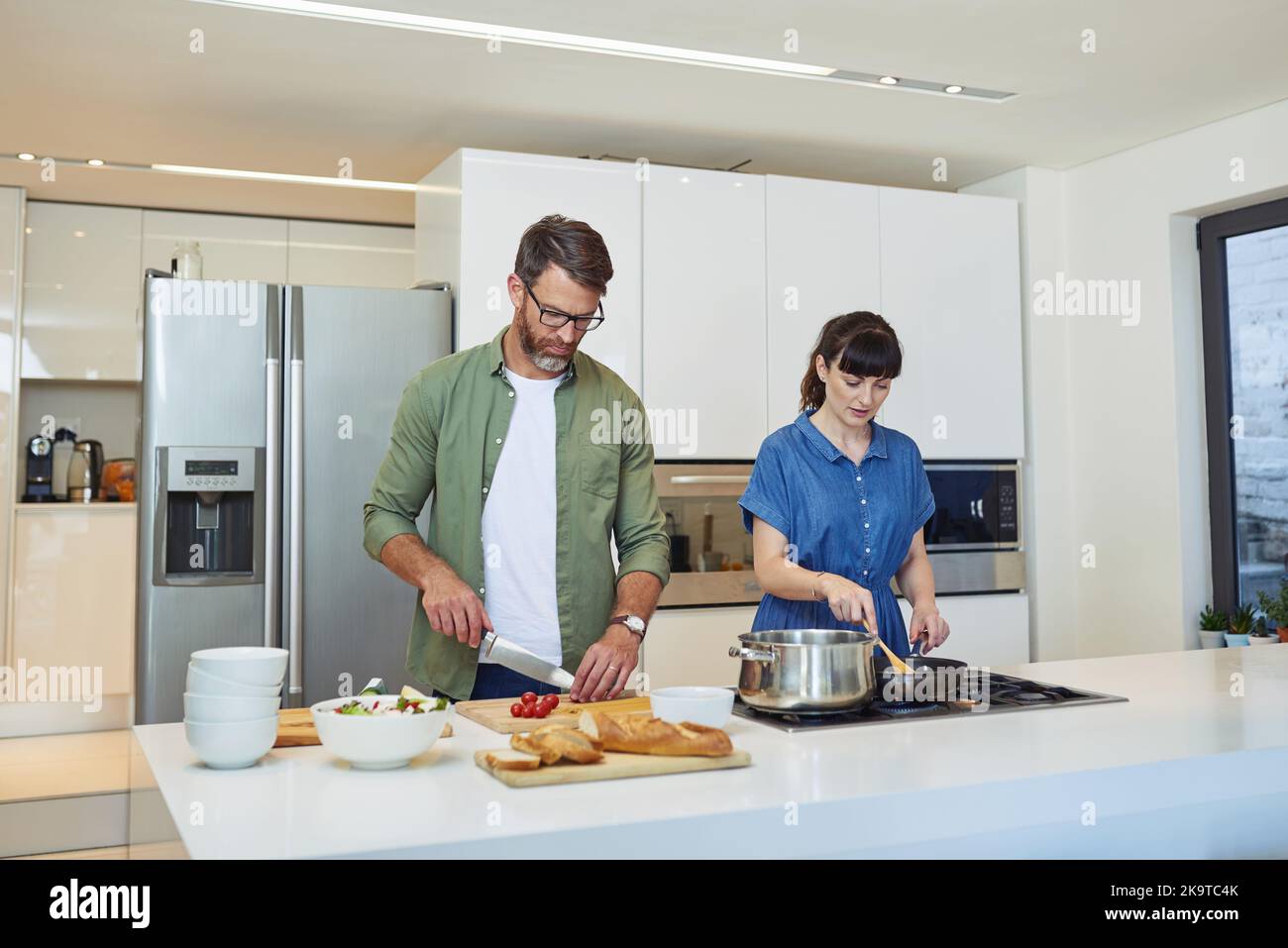 Trying out new recipes together. a mature couple cooking together at ...