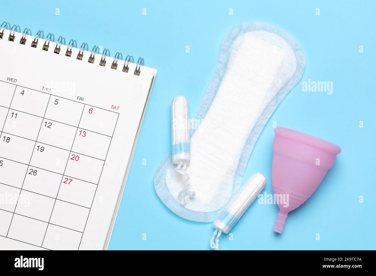 Menstruation calendar. Calendar with pads and tampons on a blue ...