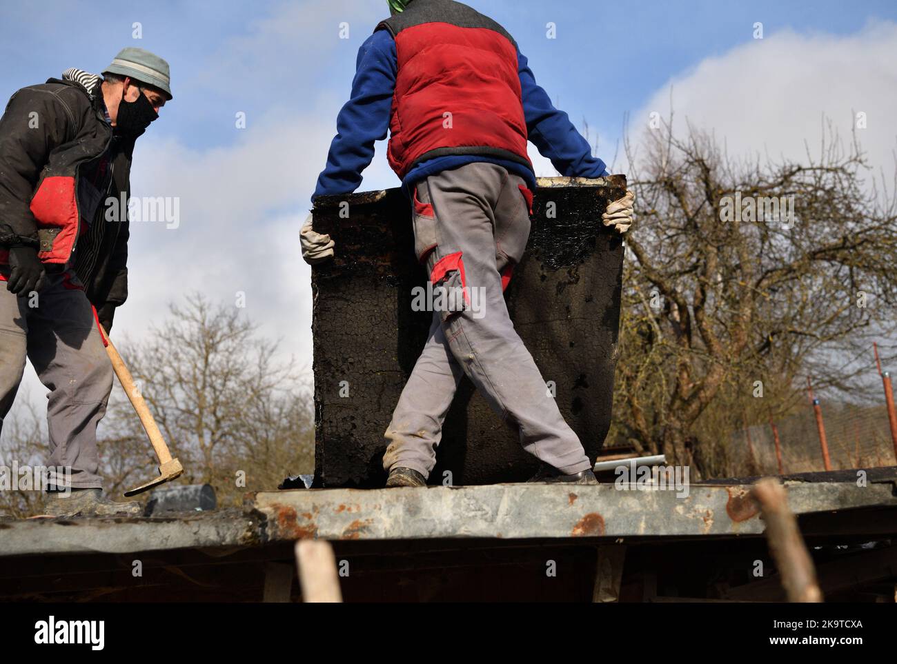 Roof workers remove metal roof during demolition Stock Photo - Alamy
