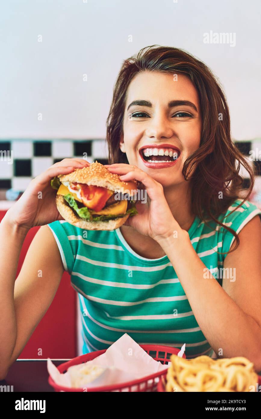 They make the best burgers. Cropped portrait of an attractive young ...