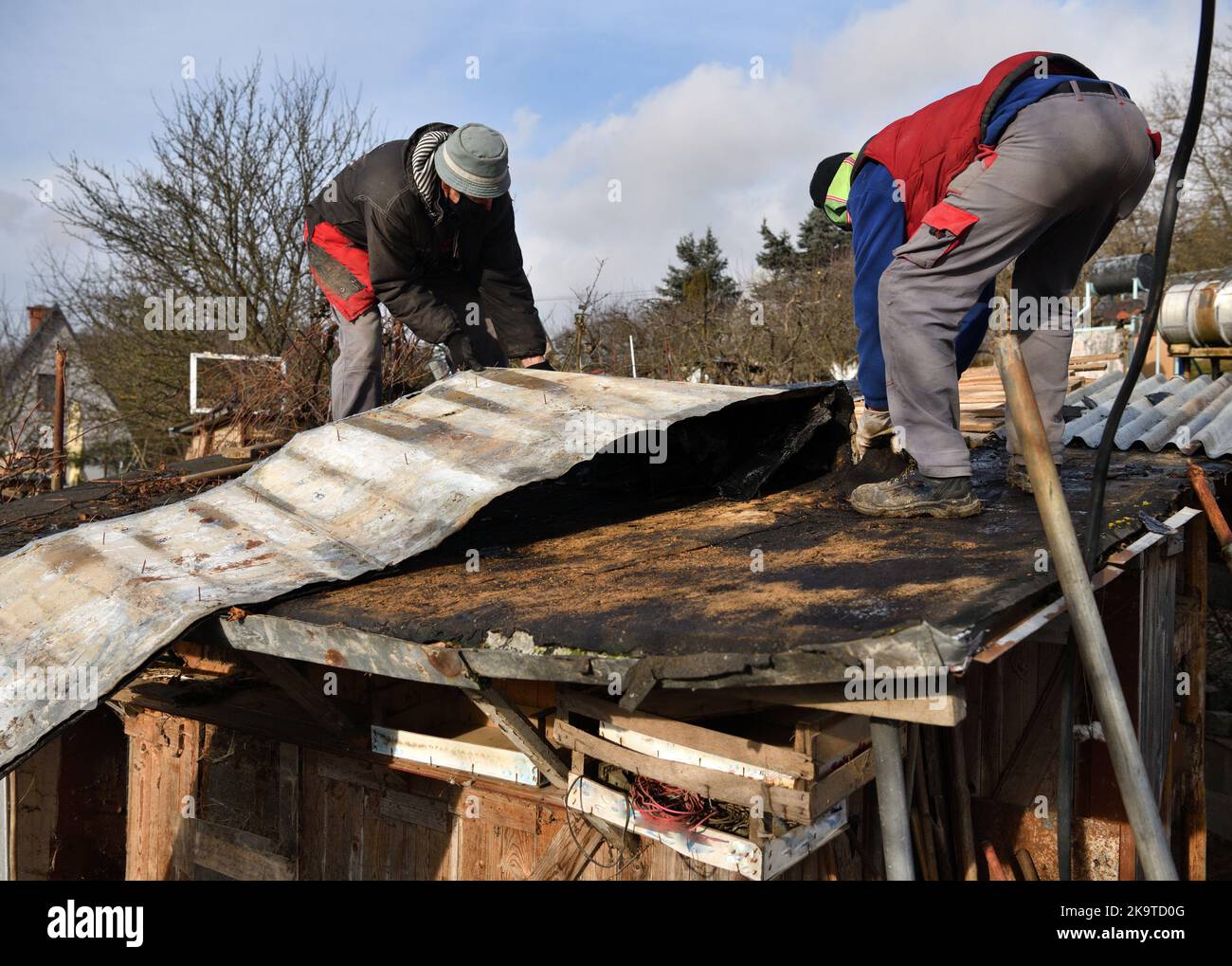 Roof workers remove metal roof during demolition Stock Photo - Alamy