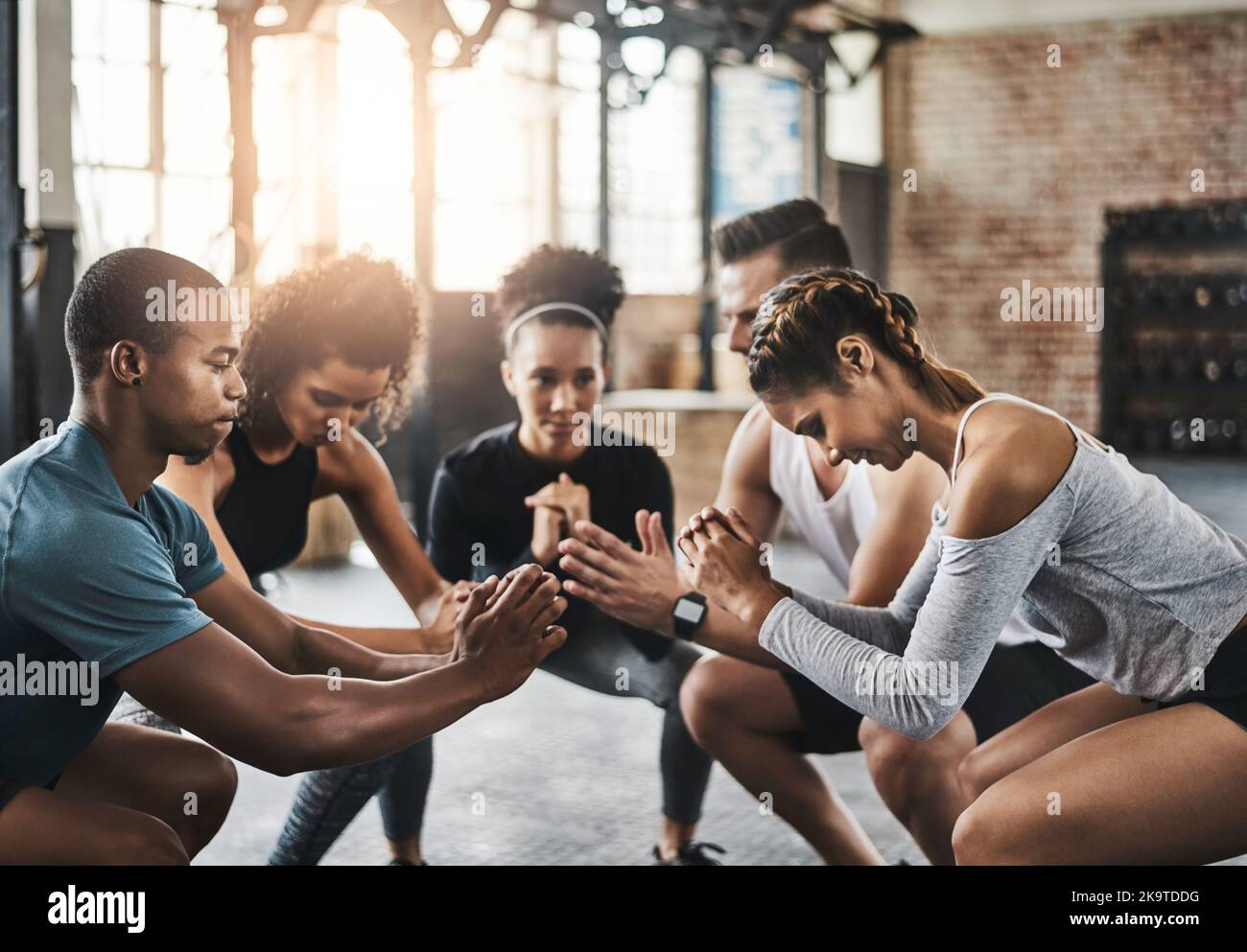 Squatting - The ultimate in lower body exercise. a group of young ...