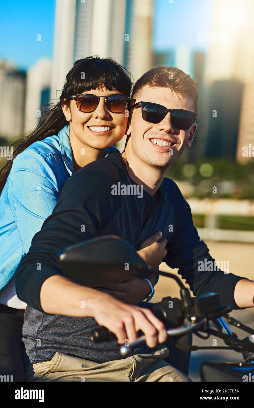 Getting around town in a fun way. a young couple out for a ride in the ...
