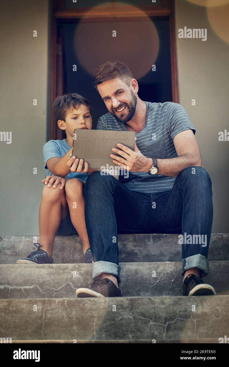 My boys ready for his first tablet. a father and son using a digital ...