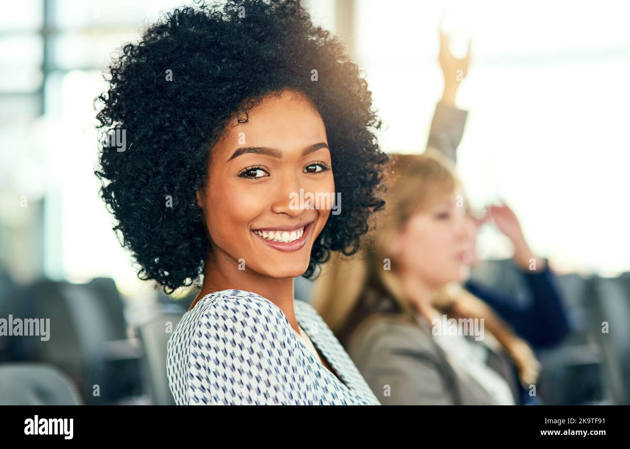 Im learning a lot. Cropped portrait of an attractive young businesswoman sitting in a conference ...