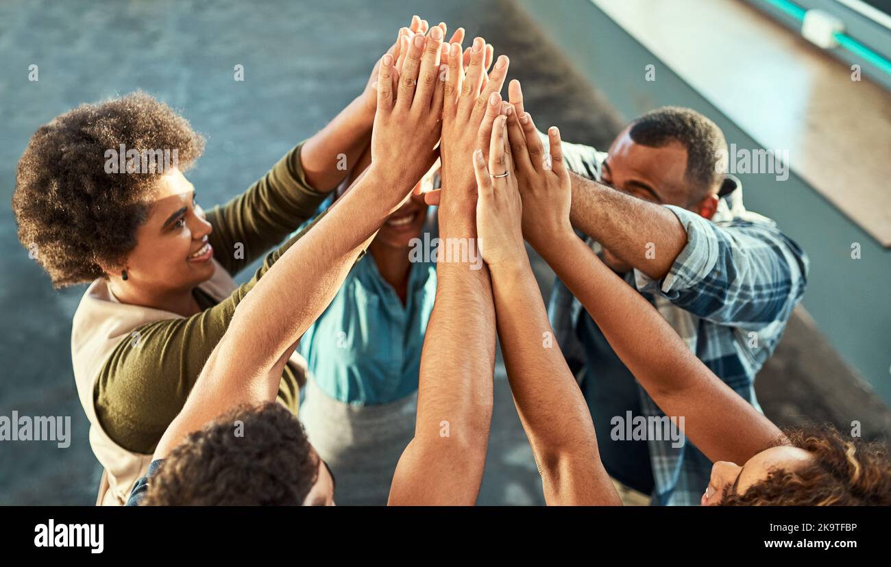 We all are leaders. a group of motivated young work colleagues forming ...