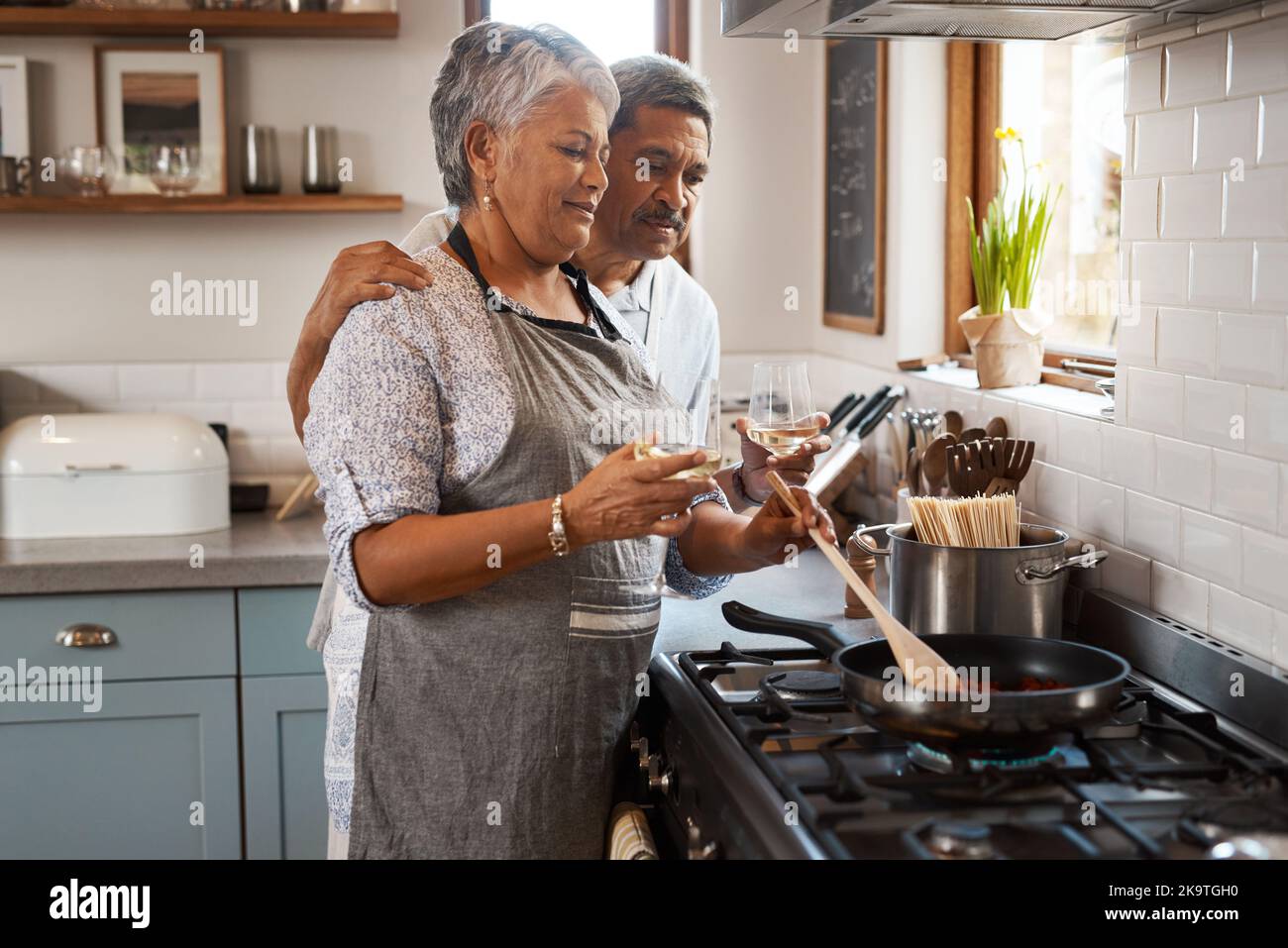 That sauce looks just right. a happy mature couple cooking a meal ...
