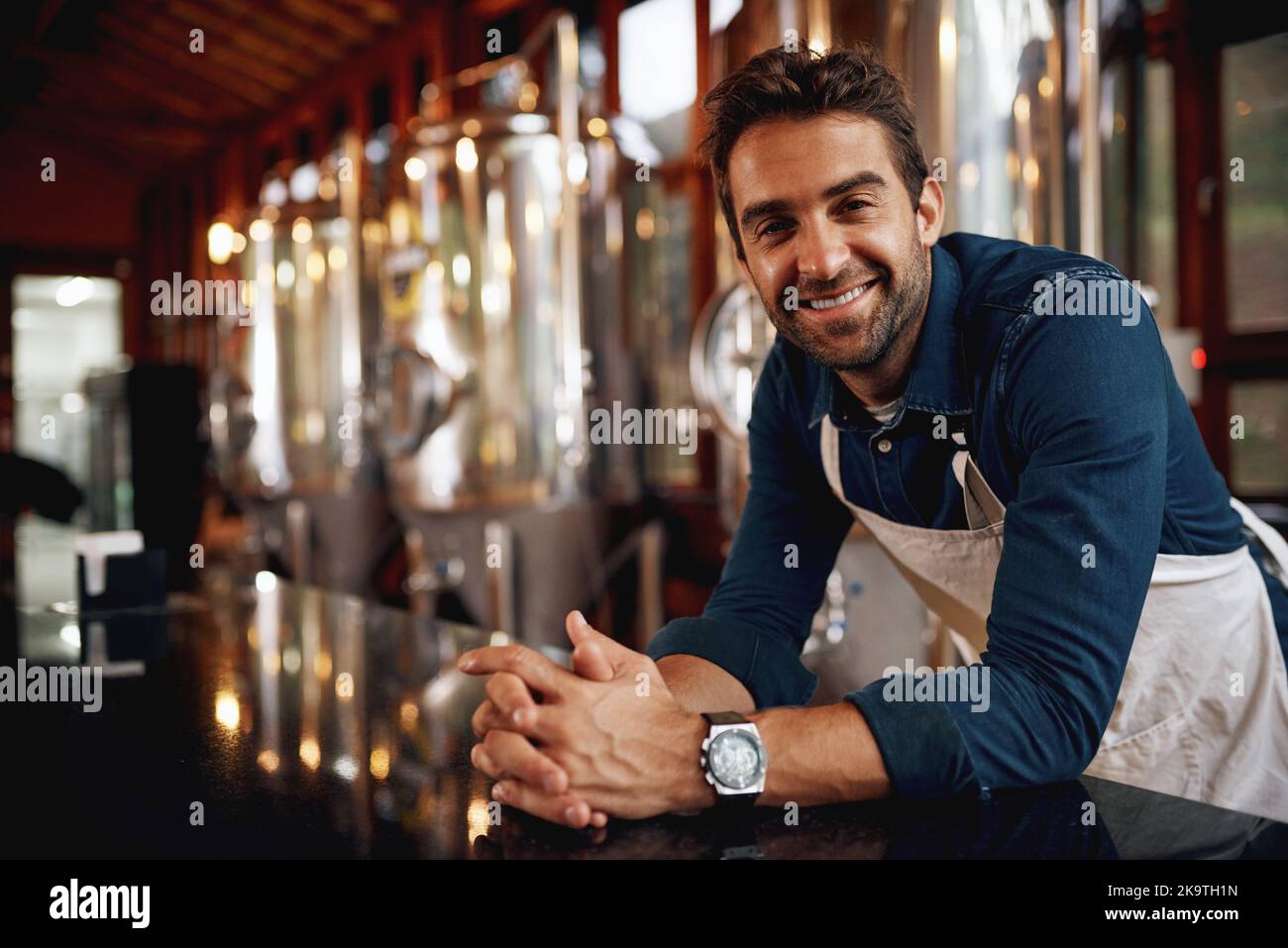 Waiting patiently for the customers. Portrait of a cheerful young ...
