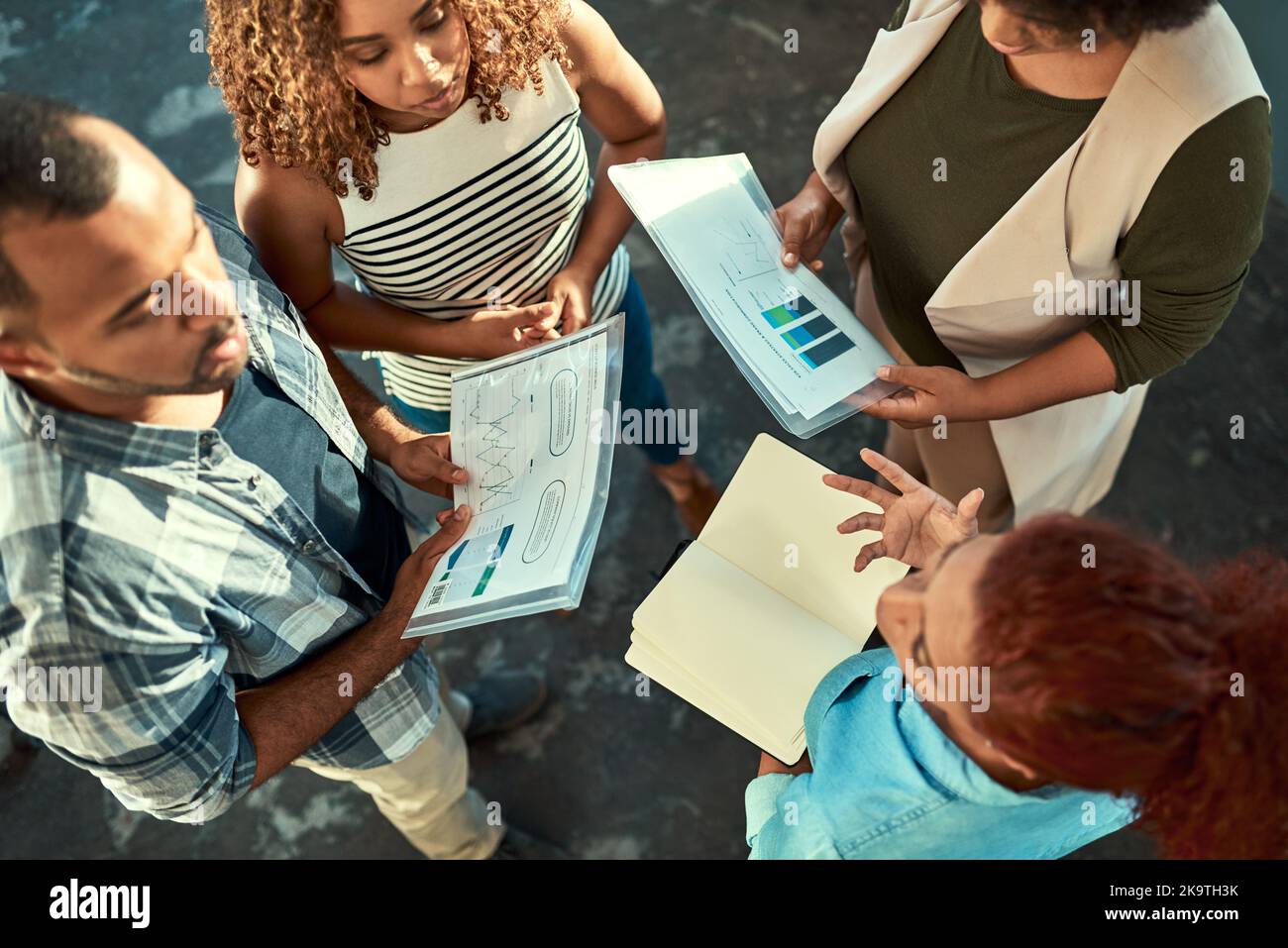Doing what our team does best. High angle shot of a group of young work ...